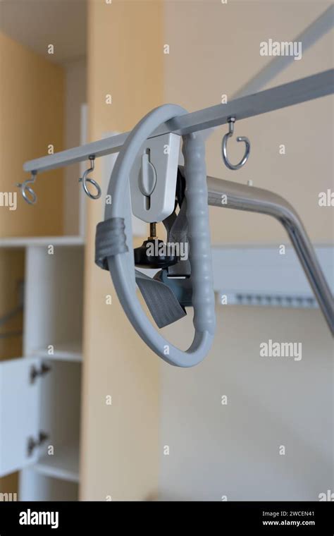 Above Hospital Bed Is Hanging Adaptive Triangular Metal Frame Gallow