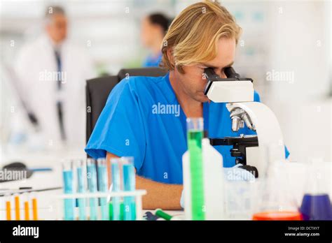 Male Scientist Looking Through Microscope In The Lab Stock Photo Alamy