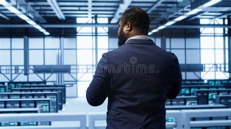 Technician Monitoring Server Room Supercomputers Doing Checkup Stock