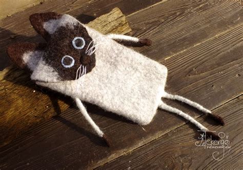 Felt Cat Lying on Wooden Floor