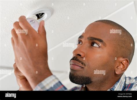 Man Fitting Spotlight In Ceiling Stock Photo Alamy