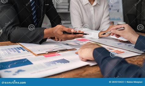 Business Team Analyzing Income Charts And Graphs In Office Close Up