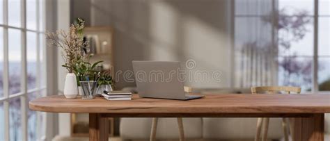 A Laptop Computer And Decor On A Wooden Table By The Window In A Cozy