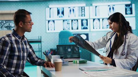 Indian General Practitioner And Patient Engage In A Medical