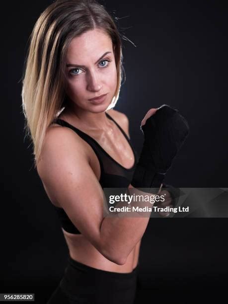 Cute Female Fitness Model With Bandaged Hands Posing And Looking At