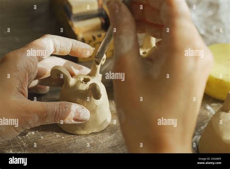 A Woman Makes Holes Using A Tool In A Clay Craft A Candlestick Close Up Hobbies And