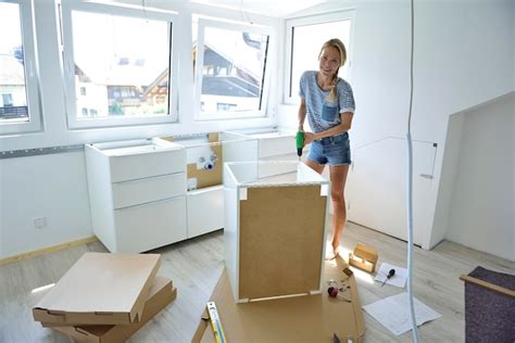 Premium Photo Woman Assembling Cabinet At Home