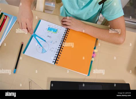 Top View Of The Hand Of A Schoolboy Holding Compass Drawing Circle