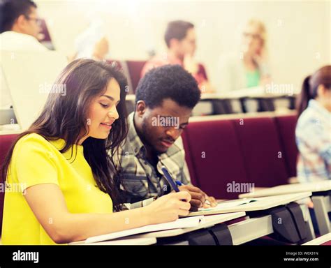 Group Of Students With Notebooks In Lecture Hall Stock Photo Alamy