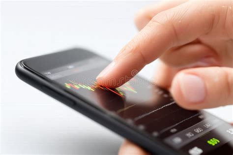 Finger Touching Smartphone Displaying Stock Chart Financial Data And Investment Monitoring