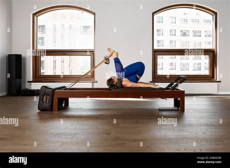 The Instructor Does Exercises On The Reformer A Beautiful Girl Trains On The Modern Reformer