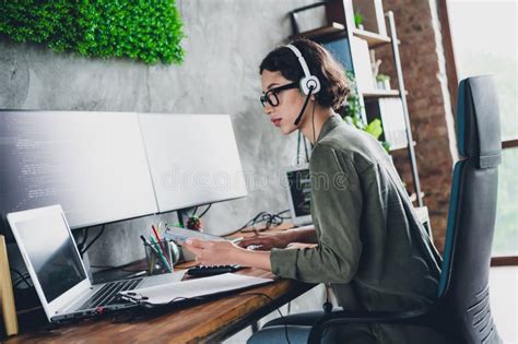 Young Female Programmer Working Remotely In A Stylish Home Office With Dual Monitors Coding