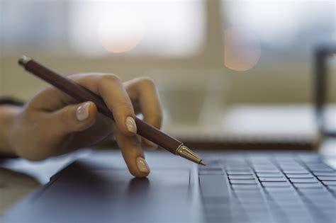 Premium Photo The Image Shows A Woman S Hands In Closeup Typing On A Contemporary Laptop