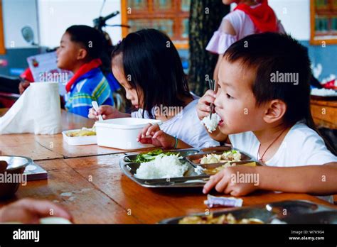Chinese Pupils Take Free Lunch At The Gantuan Primary School In