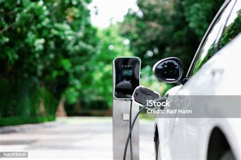 초점 근접 촬영 Ev 자동차와 진보적인 개념을 위한 흐릿한 배경의 충전기 전기 자동차 대체 연료 자동차에 대한 스톡 사진 및