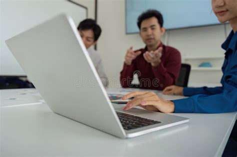 Focused Discussion And Design Review Team Members Discussing Ux Strategies While Referencing