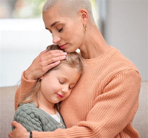 Moms Got You A Young Mother Comforting Her Daughter On The Sofa At