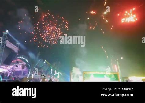 Crowd Of People Flow In Countdown To Next Year With Fireworks Stock