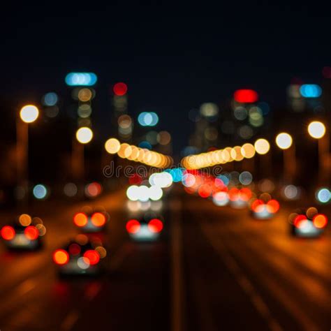 Blurred Image Of A Night City Scene With Out Of Focus Streetlights And