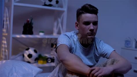 Lonely Teen Boy Sitting In Dark Room Thinking About Life Problems