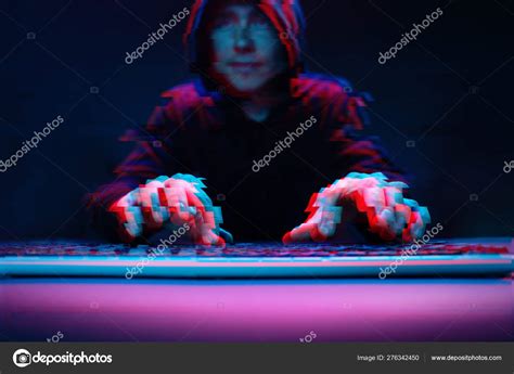 Hacker In The Hood Working With Computer Typing Text In Dark Room Image With Glitch Effect
