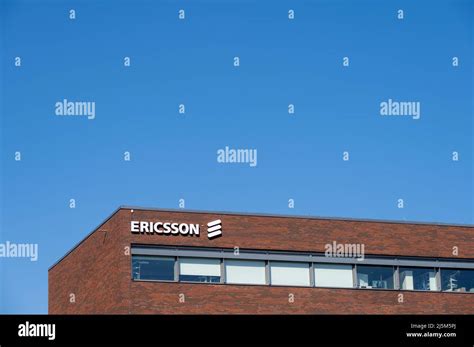 Lund Sweden April 22 2022 The Logo Of Ericsson Mounted On The Brown Brick Facade Against