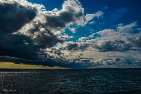 This Is A Photo Capturing A Cloudy Sky Over Water Taken By Danny Ryan