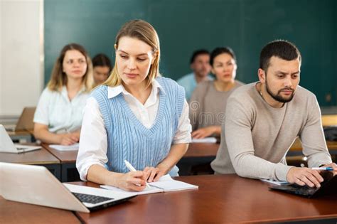 Focused Students Write Down The Lecture Synopsis During The Class Stock