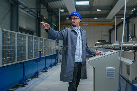 African American Professional Factory Engineer Updating Industrial Control Panel Stock Image