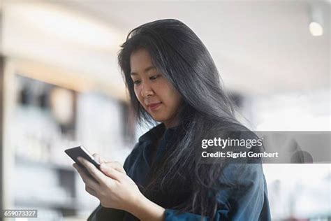 Young Woman Text Messaging On Mobile Phone Freiburg Im Breisgau Badenwürttemberg Germany High