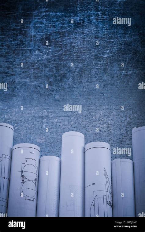 Vintage Scratched Shiny Metallic Background With Rolled Blueprints Copy Space Image Construction