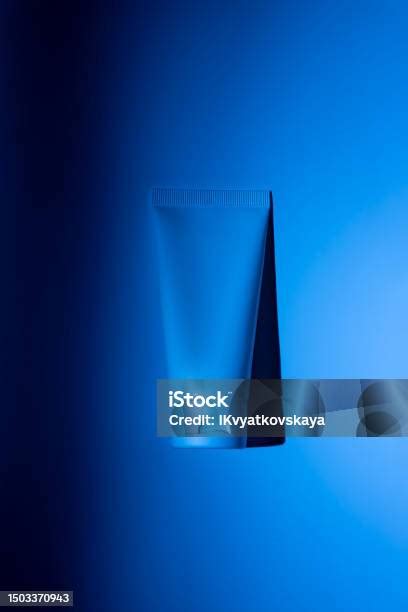 의약품 또는 화장품의 브랜딩을 위한 흰색 스퀴즈 병 플라스틱 튜브의 모형 크림 젤 스킨 케어 치약 파란색 네온 배경에 화장품 병 용기 미니멀리즘 0명에 대한 스톡 사진 및