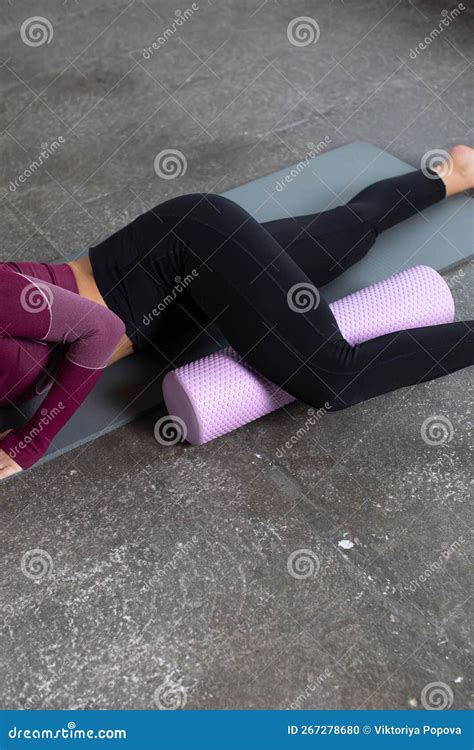 A Young Woman In Sportswear Performs A Myofascial Hip Massage With A