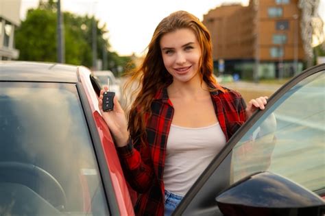 Premium Photo Standing Gracefully Beside A Recently Purchased Red Car A Redhead Woman Holding Keys