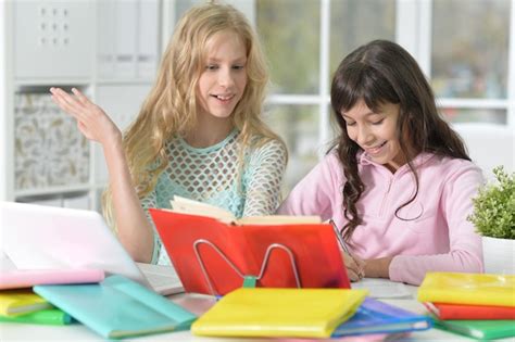 Premium Photo Portrait Of Girls Doing Lessons Together At Home