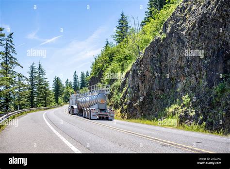 Powerful White Big Rig Semi Truck Tractor Transporting Cargo In Cone