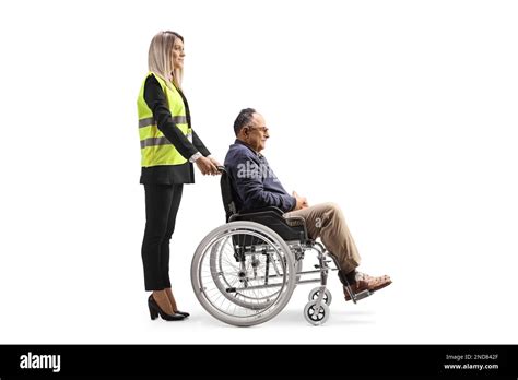 Female Special Assitance Worker Standing With A Marture Man In A Wheelchair Isolated On White