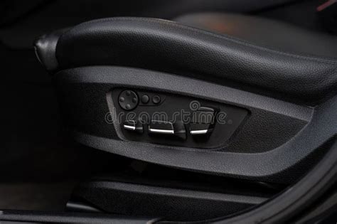 Close Up Of Black Leather Car Seat With Various Buttons For Adjusting