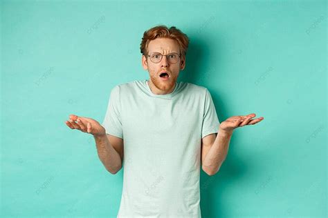 redhaired guy with glasses baffled by strange object photo background