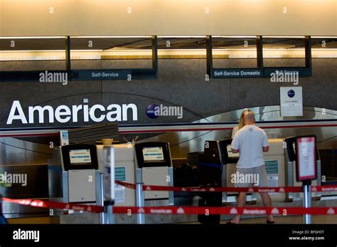 A Man Checks In For His Flight At The American Airlines Ticket Counter