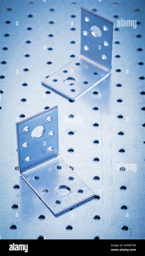 Stainless Perforated Angle Fasteners On Metallic Background