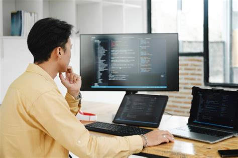 premium photo it programmer starts working on desktop computer the
