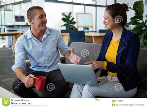 Business Executives Interacting with Each Other while Using Laptop Stock Image - Image of classy ...