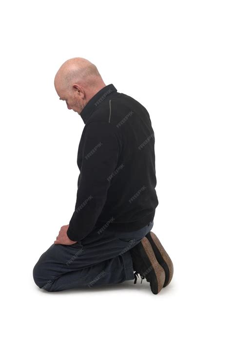 Side View Of A Man Kneeling On The Floor In White Background Premium