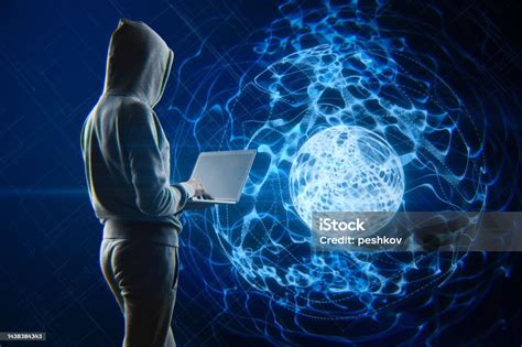 hacker using laptop with glowing blue linear sphere on blurry