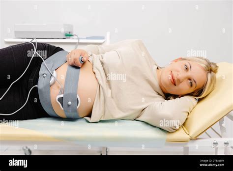 Woman Pregnant Checking Fetal Heart Beat By Fetal Monitoring Expectant Mother With Midwife