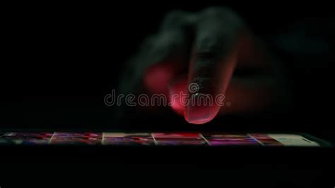 Scroll Through The Photo Gallery On Your Smartphone In The Dark With Your Finger Stock Image