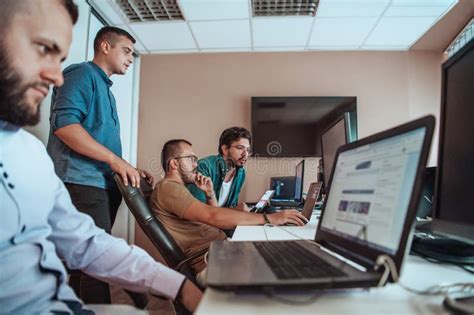 Programmers Engrossed In Deep Collaboration Diligently Working Together To Solve Complex