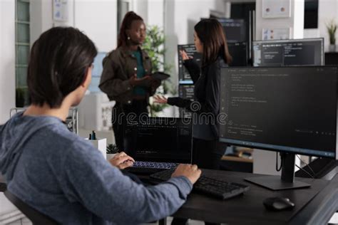 asian web developer analyzing compiling code looking at computer and