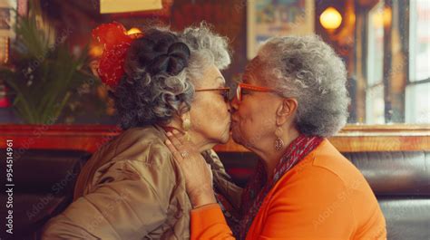 Two Old Black Women Kissing Each Other On The Couch A Couple Of Older
